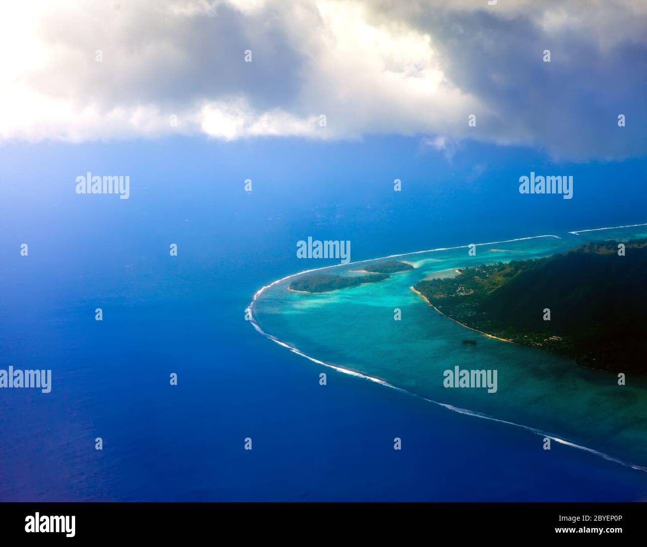 Polynesia. The atoll in ocean through clouds. Aeri Stock Photo - Alamy