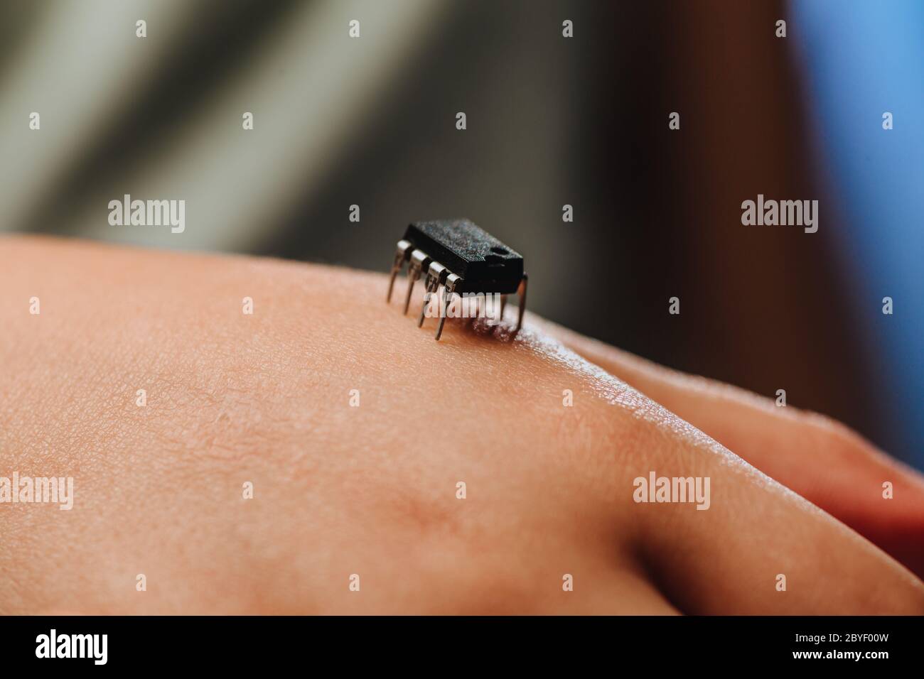 Implantation of a small black chip in hand. Chipization of people after ...