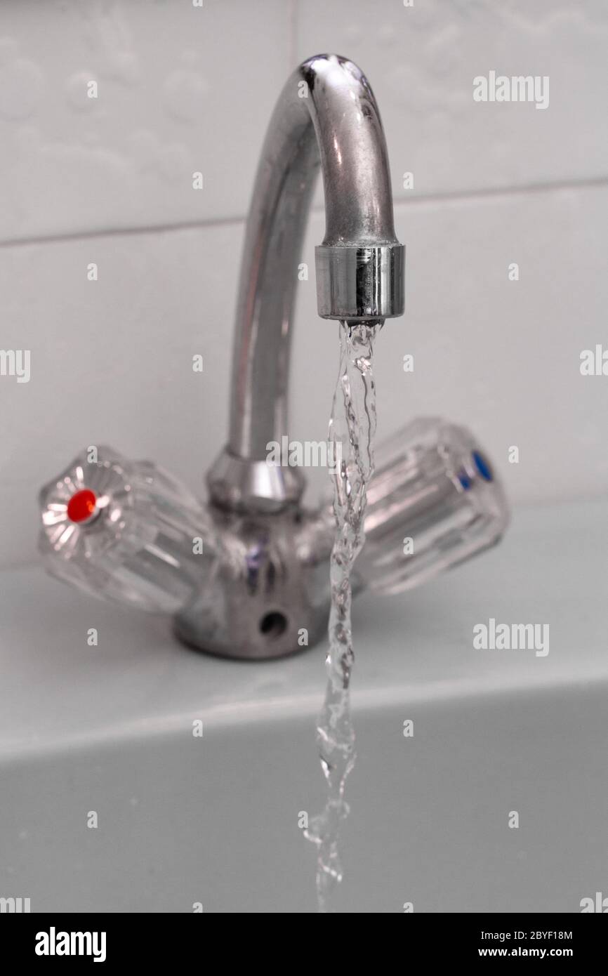 Water tap with flowing water Stock Photo - Alamy