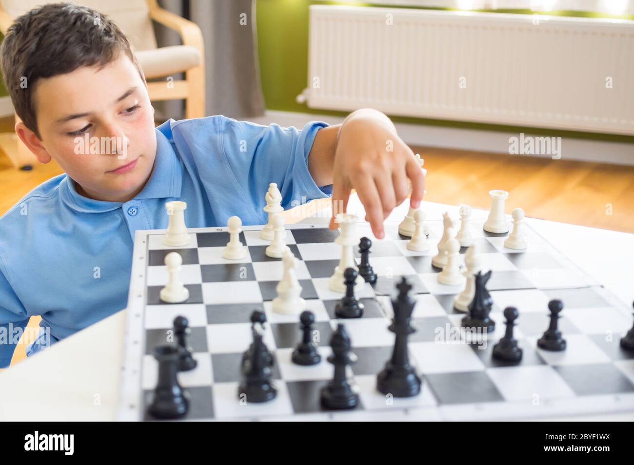 Young Boy Playing Chess indoor Stock Photo - Alamy
