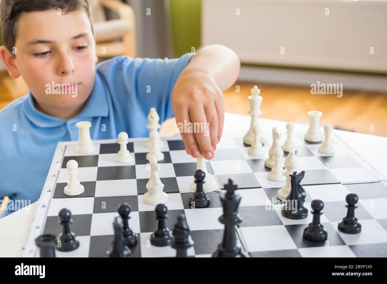 Young Boy Playing Chess indoor Stock Photo - Alamy