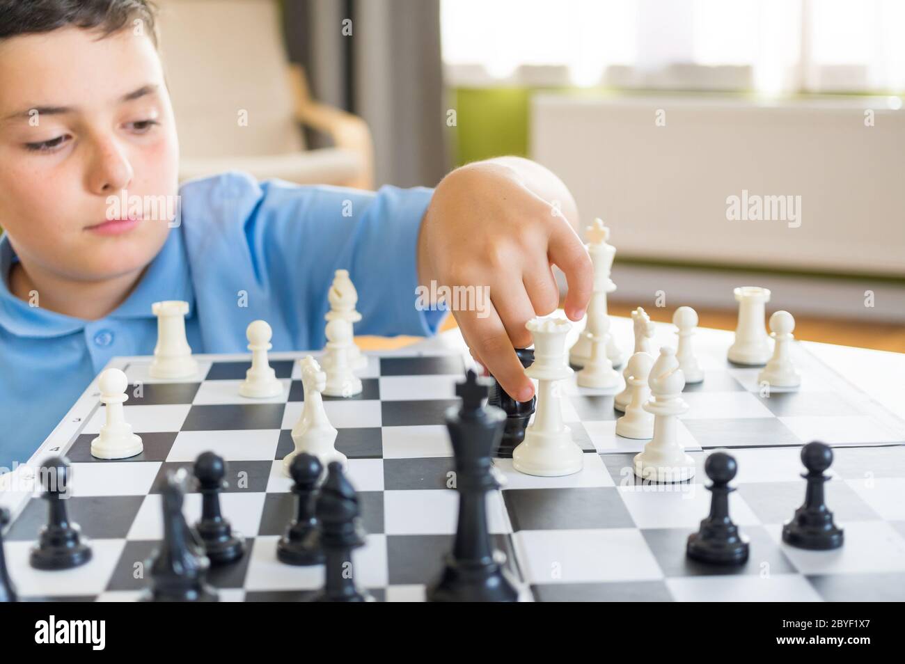 Young Boy Playing Chess indoor Stock Photo - Alamy