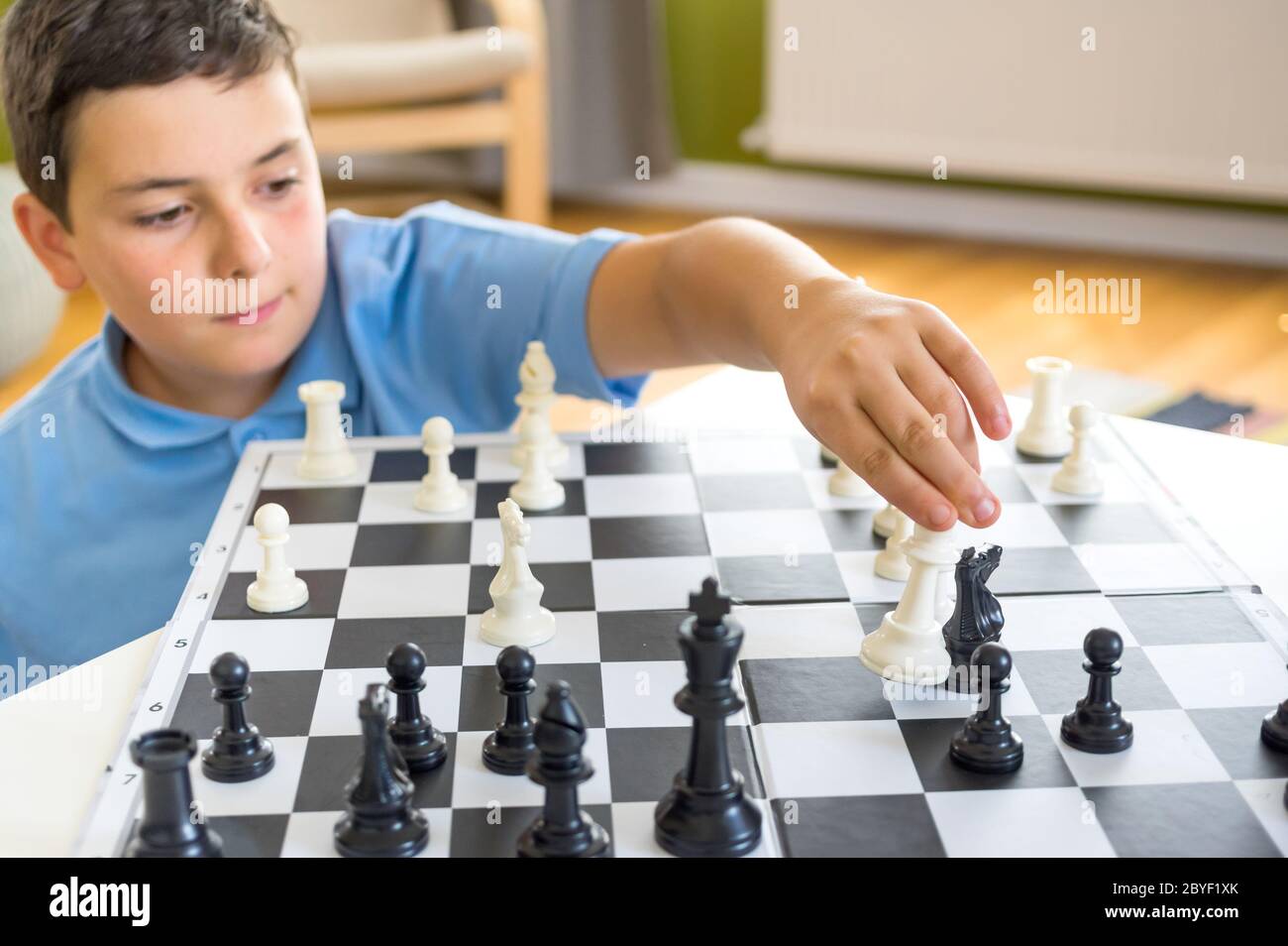 Young Boy Playing Chess indoor Stock Photo - Alamy