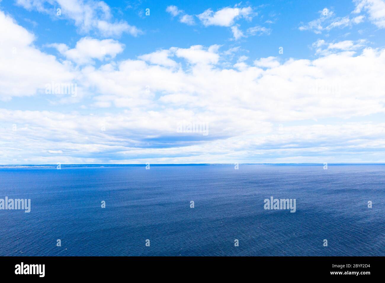 Aerial view of a blue sea water background and sun reflections. Aerial ...