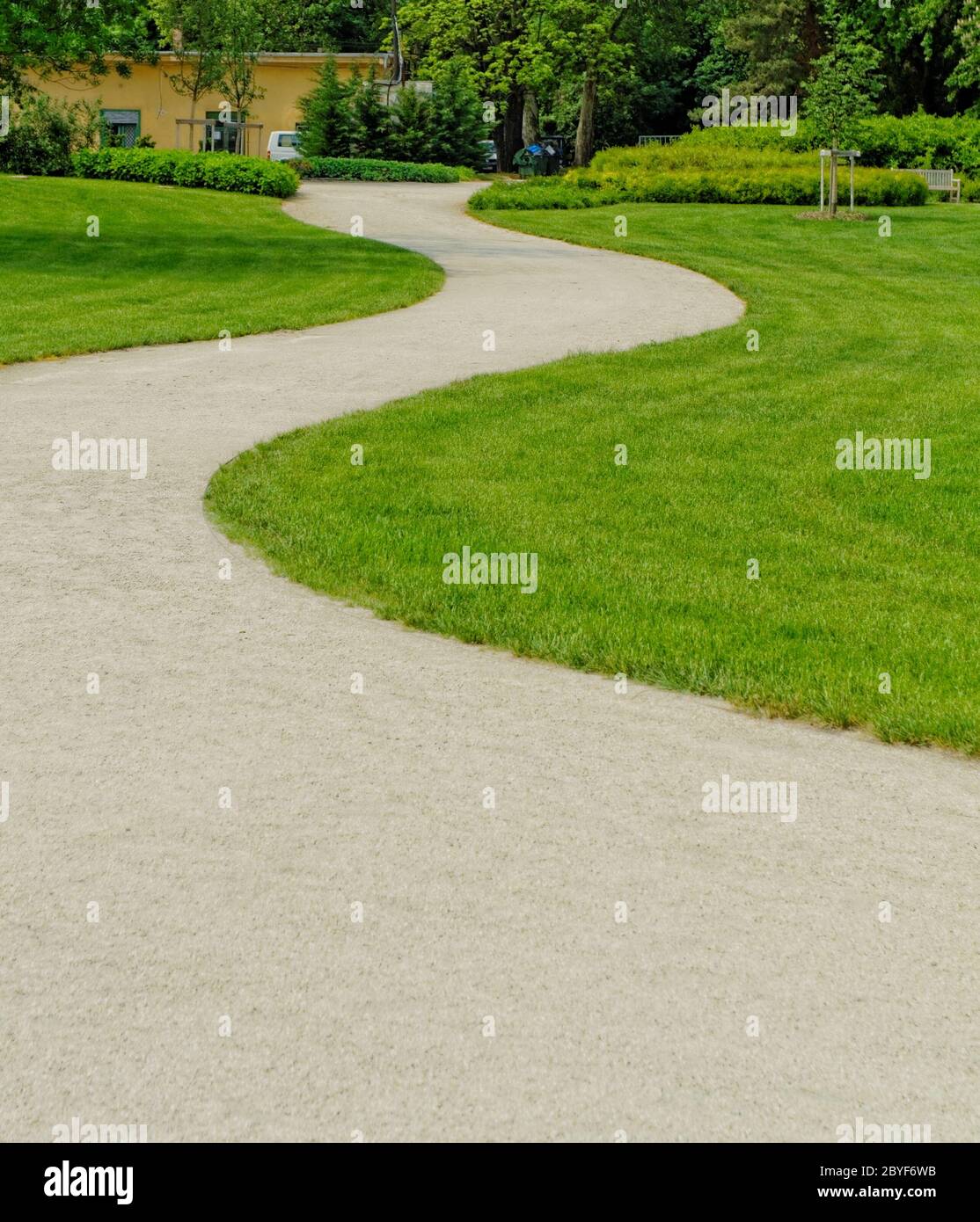 Winding path through a peaceful green garden Stock Photo - Alamy