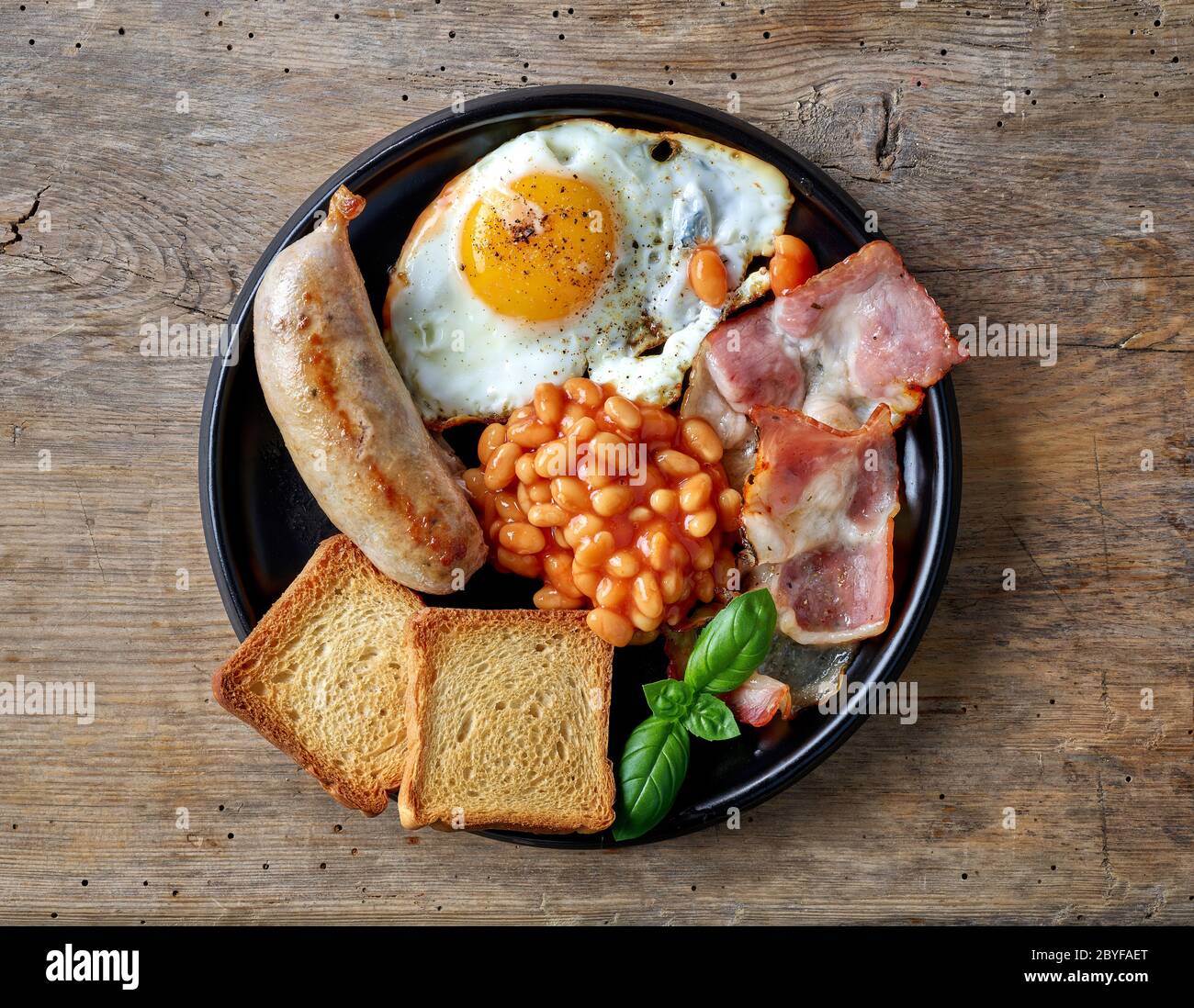 plate of english breakfast on wooden table, top view Stock Photo - Alamy