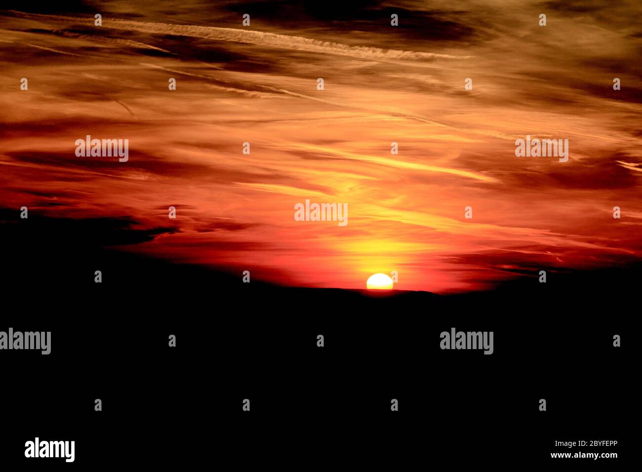 Red sunset sky stormy clouds Stock Photo - Alamy