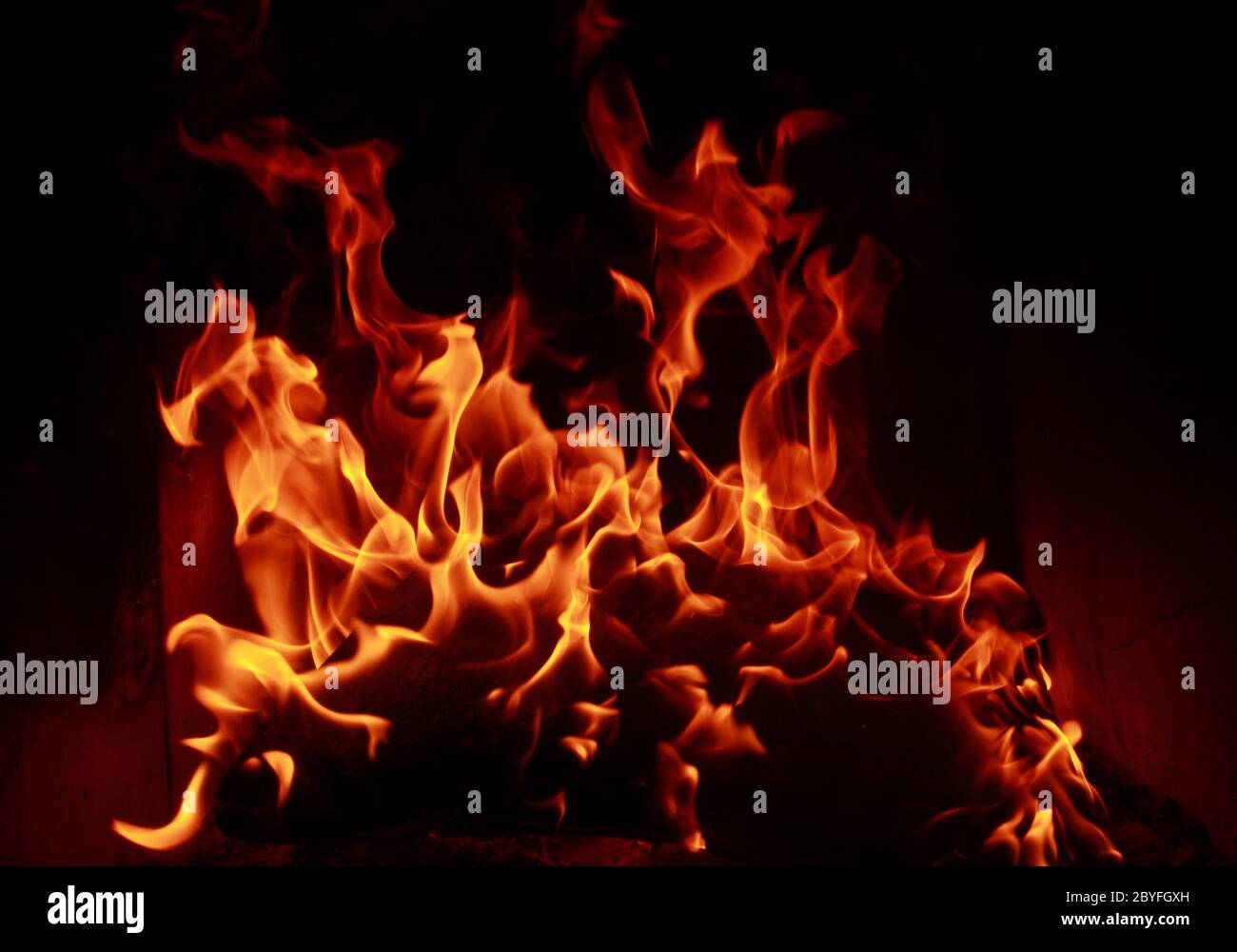 Fire flames with reflection on dark background Stock Photo - Alamy