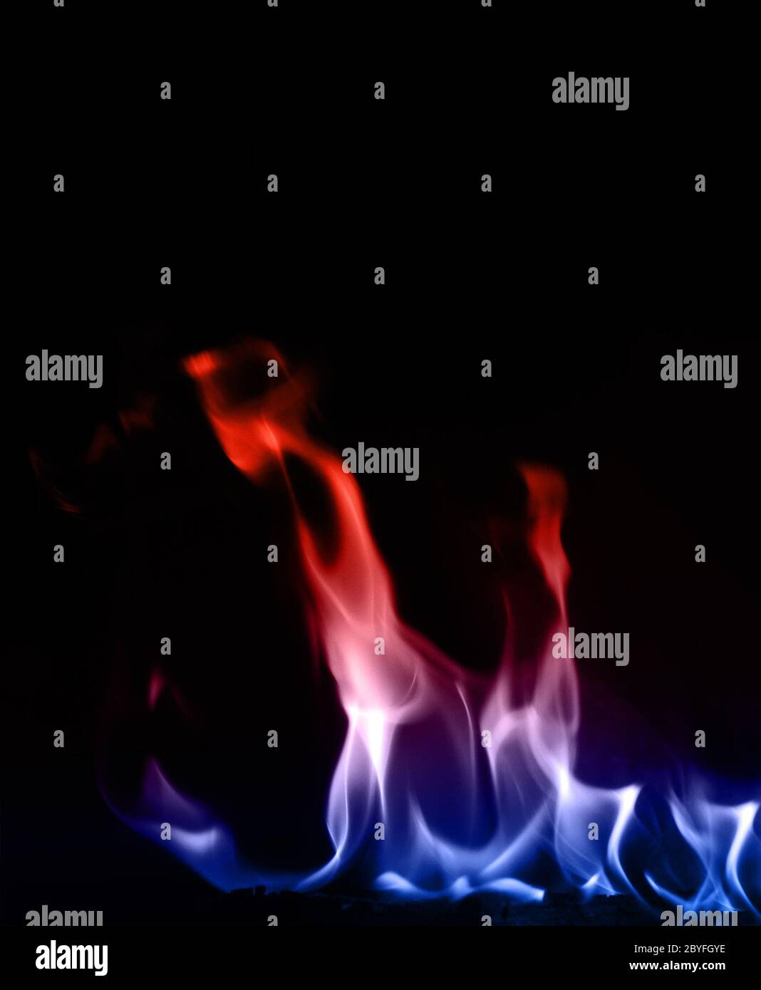 Blue and red flame isolated on dark background Stock Photo - Alamy