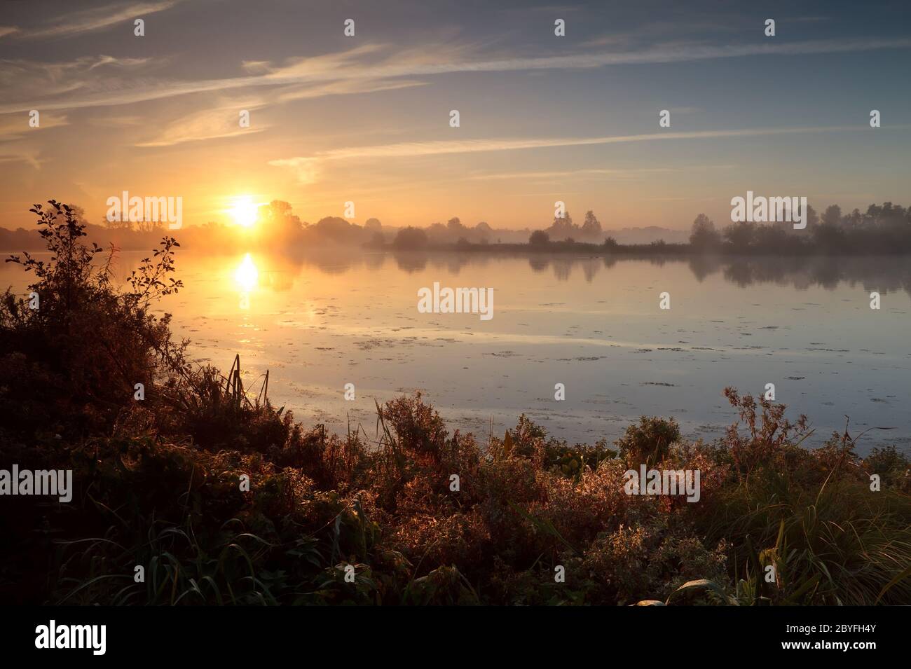 Sun rising over misty lake hi-res stock photography and images - Alamy
