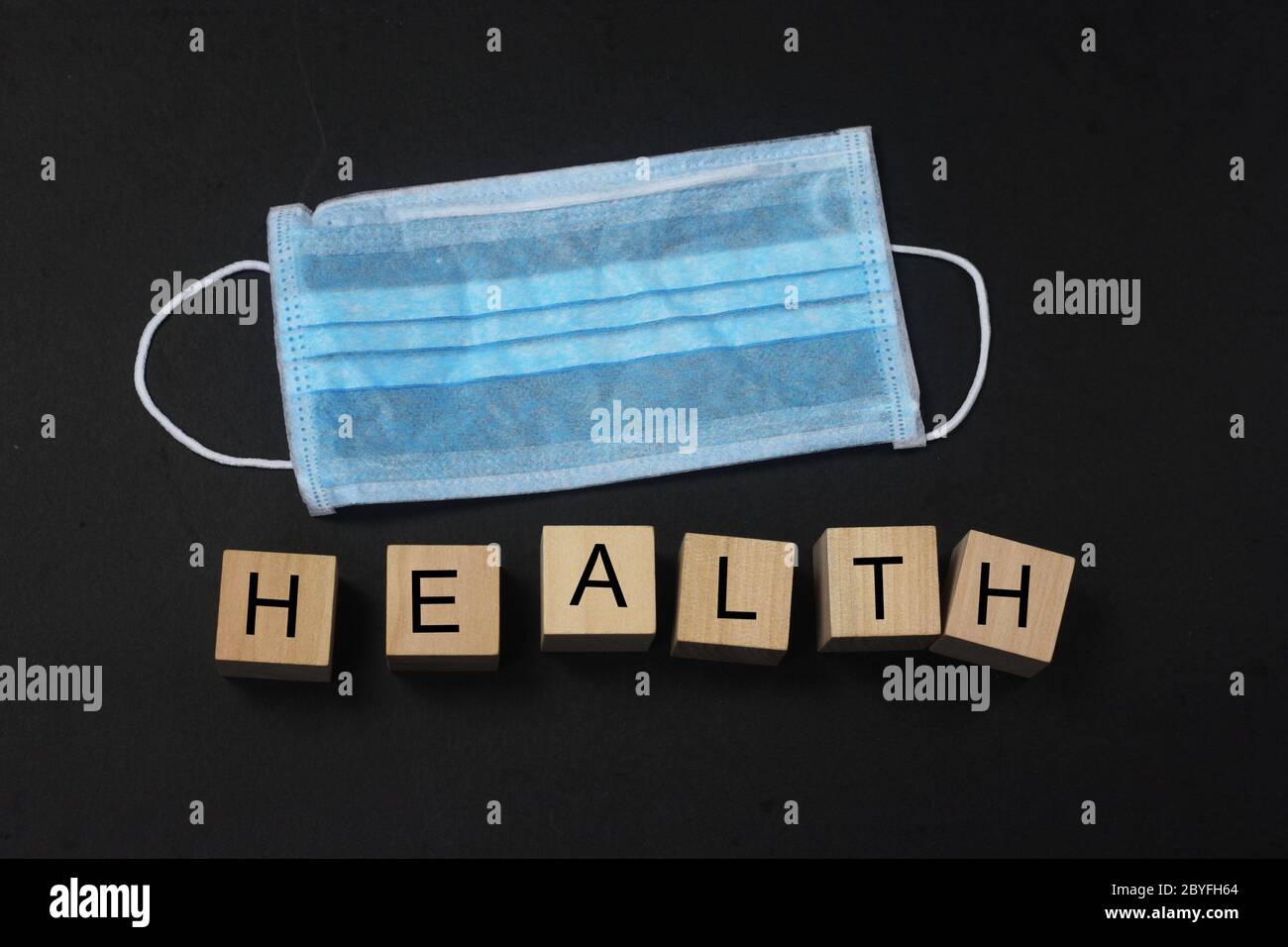 HEALTH wording on wood blocks and face mask Stock Photo - Alamy