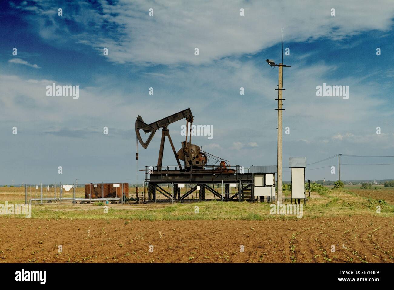 Operating oil and gas well on the meadow Stock Photo - Alamy