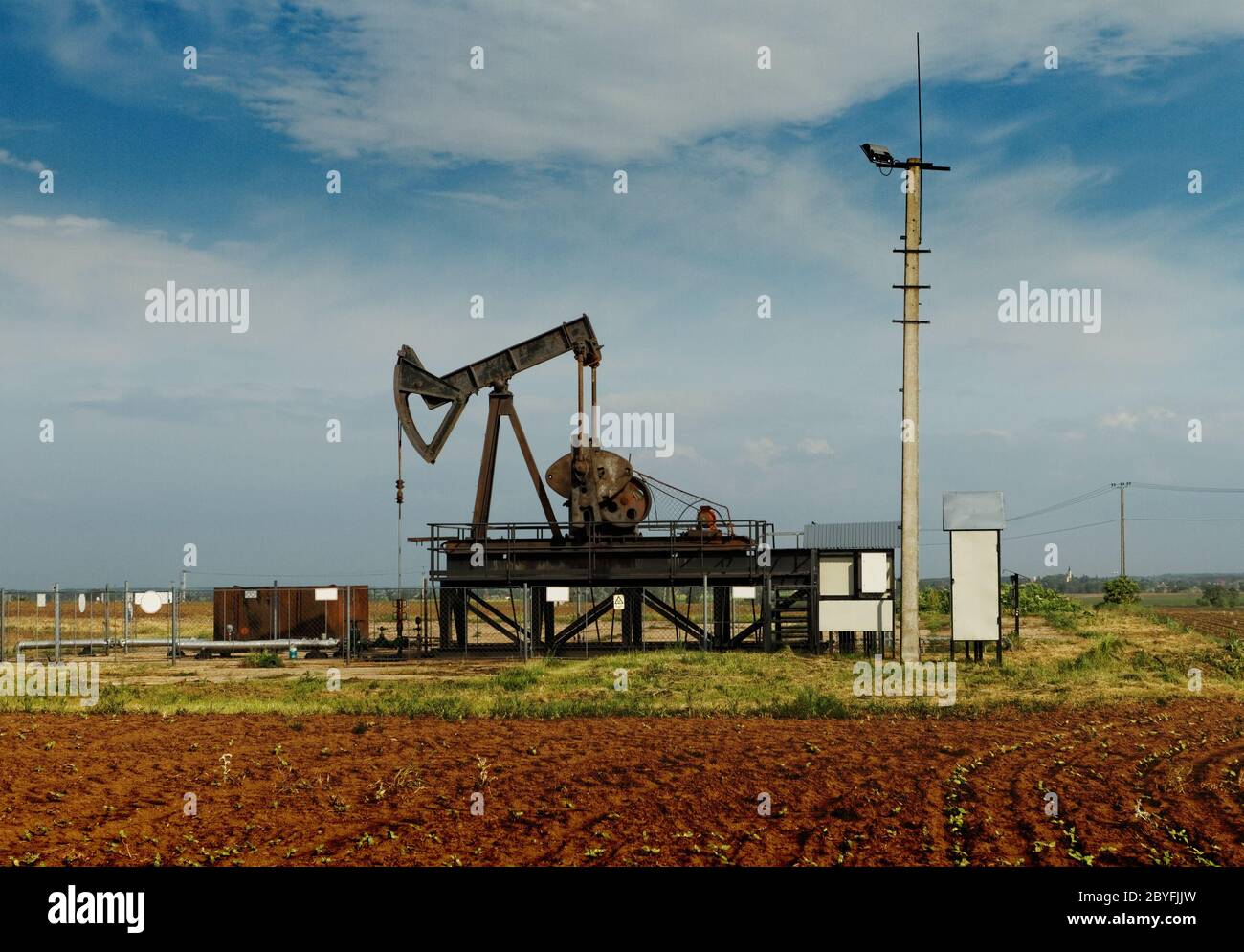 Operating oil and gas well on the meadow Stock Photo - Alamy