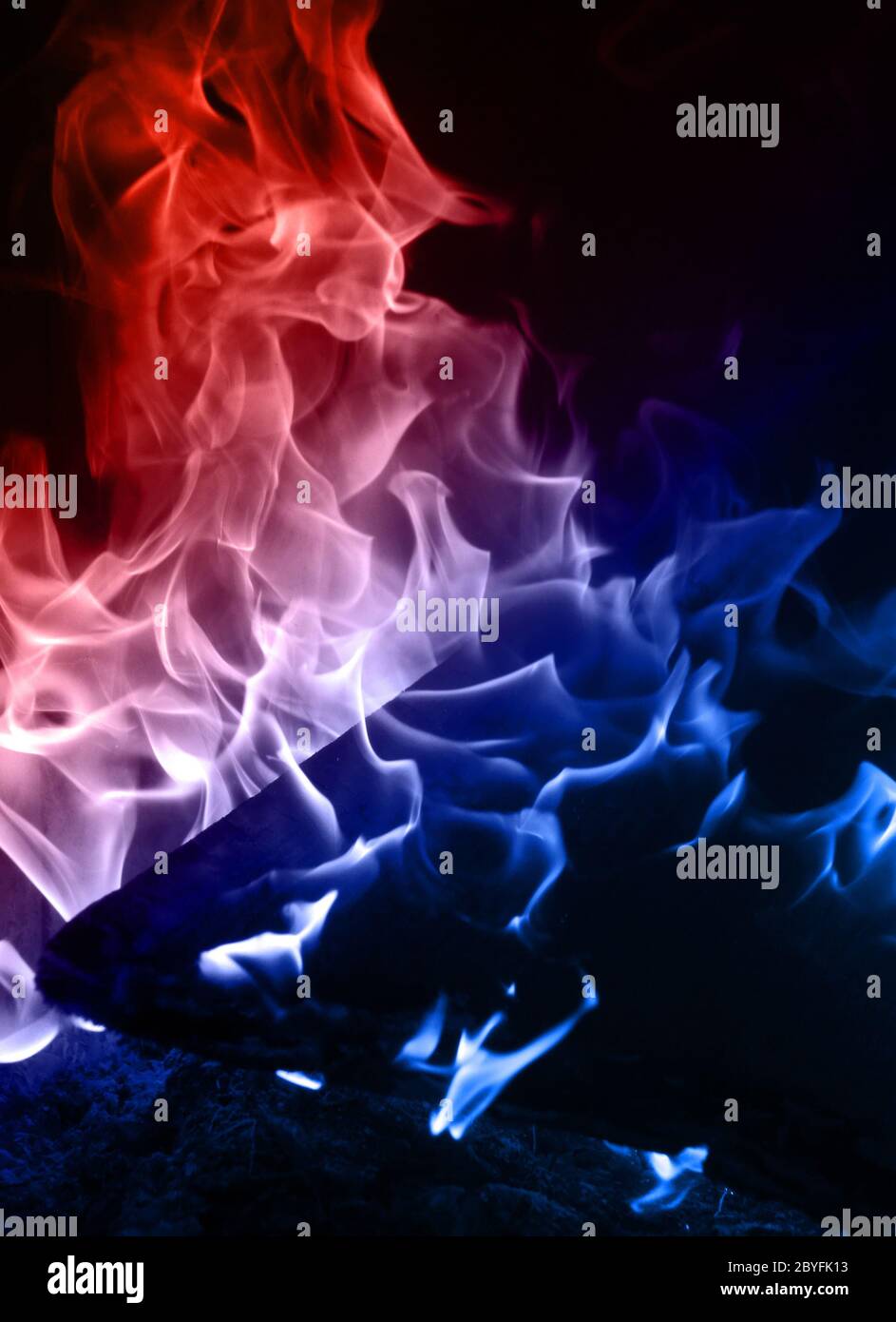 Blue and red flame isolated on dark background Stock Photo - Alamy