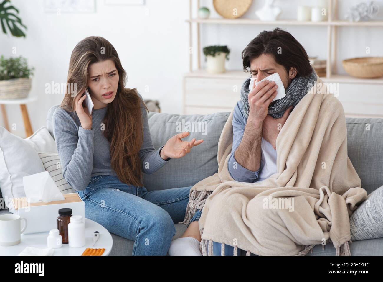 Worried wife calling doctor, husband got sick Stock Photo - Alamy