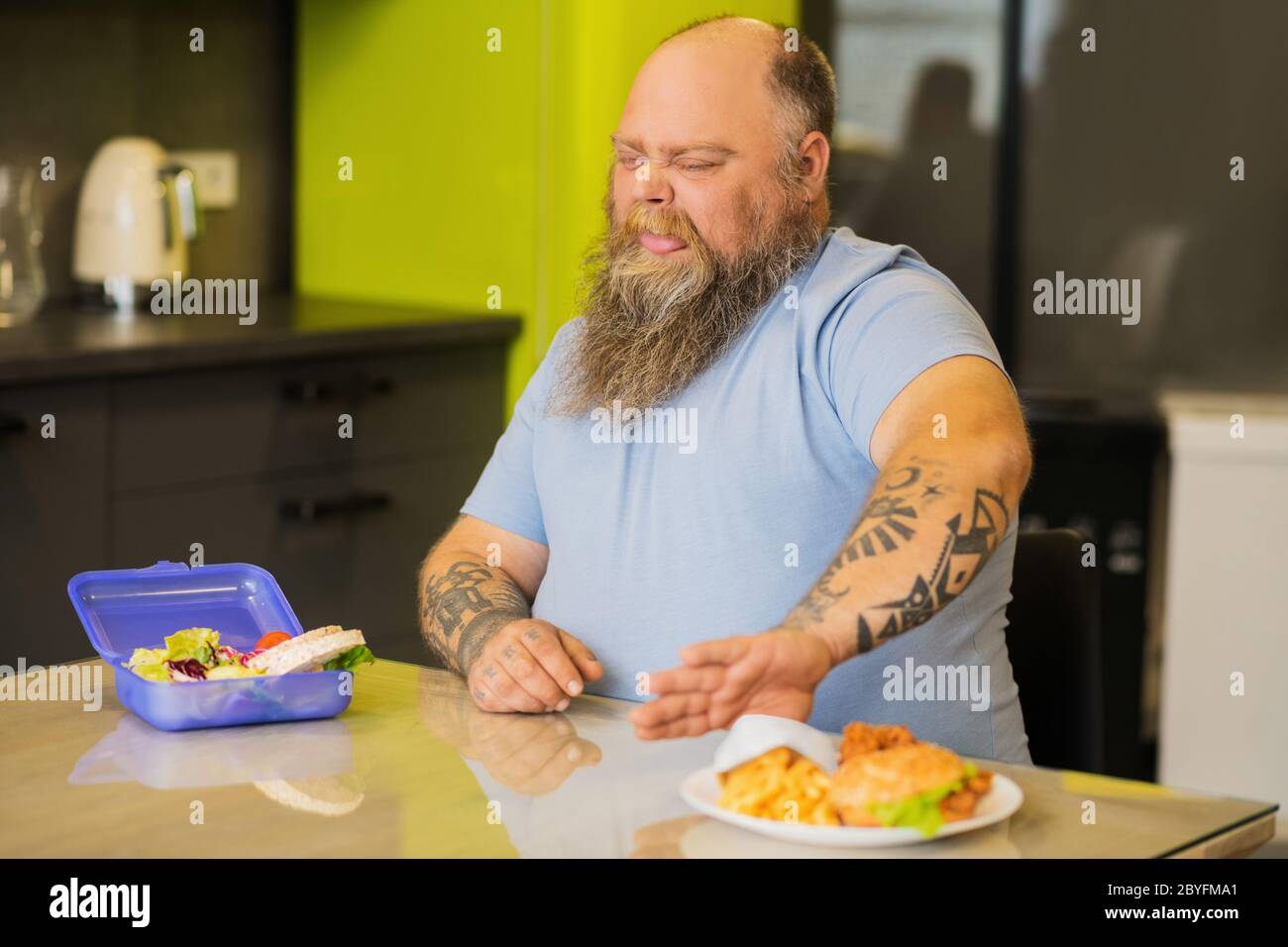 Fat man sitting eating hi-res stock photography and images - Alamy