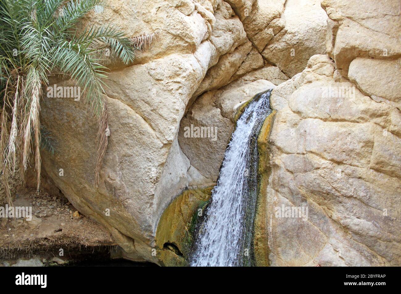 A waterfall flows from the mountain Stock Photo - Alamy