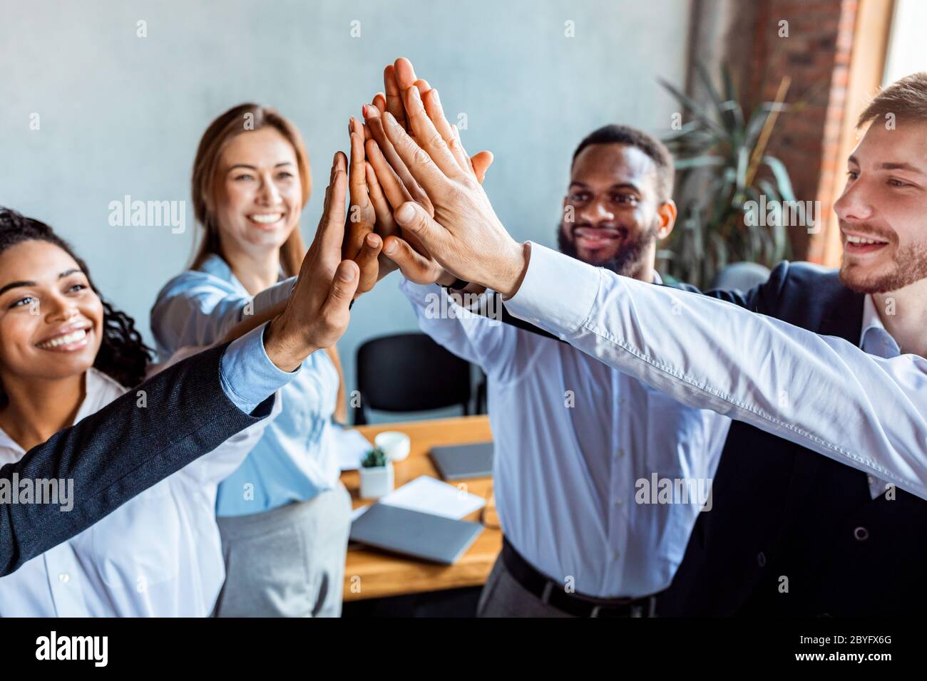 Colleagues Giving High-Five Celebrating Business Success Standing In ...