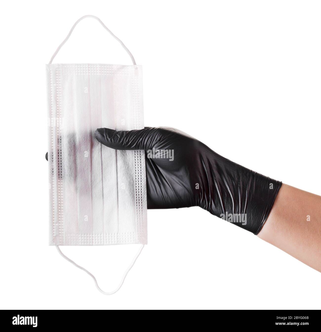 Hand in black gloves holding disposable face mask isolated on white ...