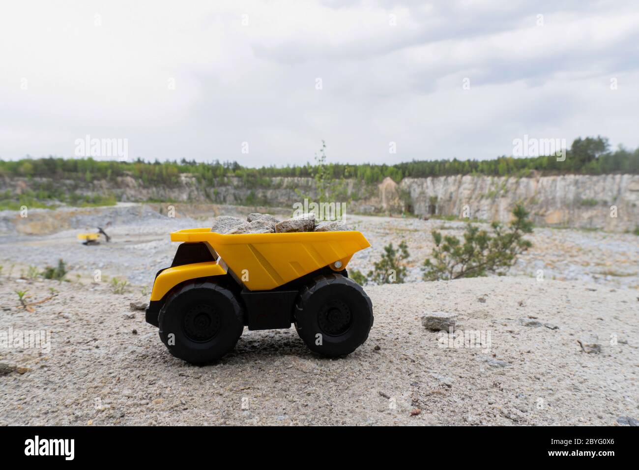 Yellow mining truck with stones at high mountain near quarry Stock ...