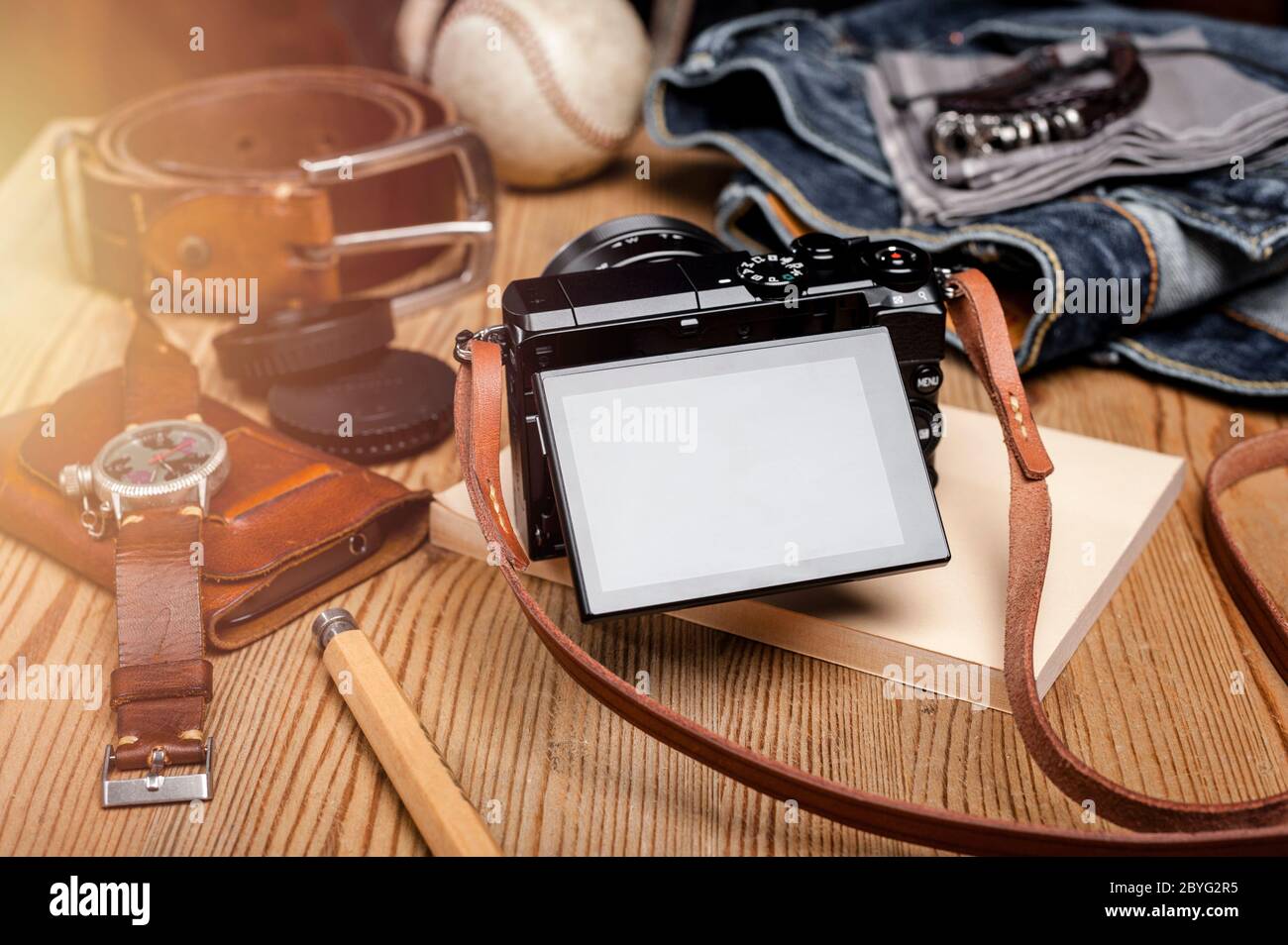 closeup blank screen of digital mirrorless camera with leather strap ...