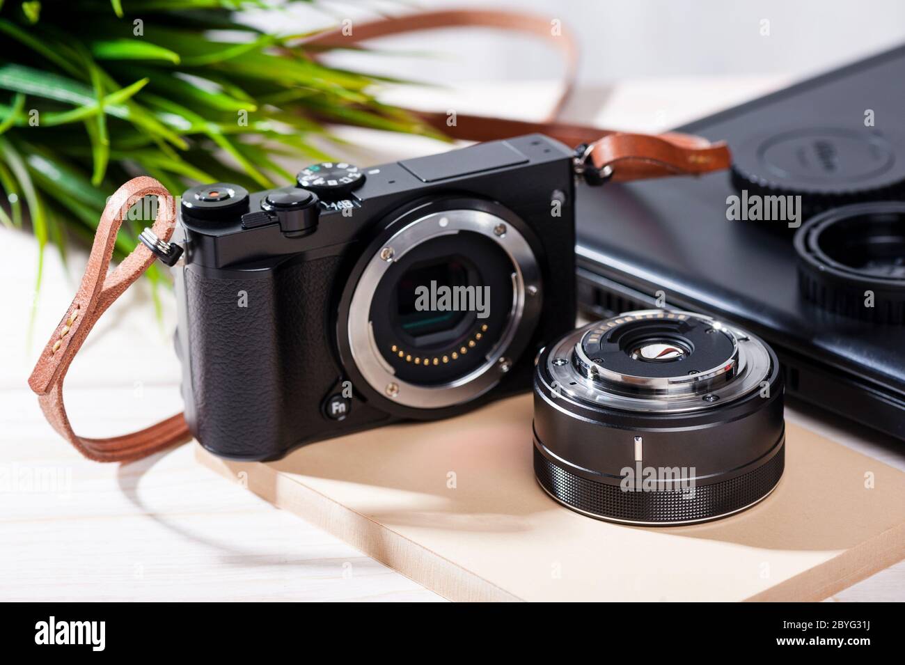 closeup vintage style of digital mirrorless camera with leather strap ...