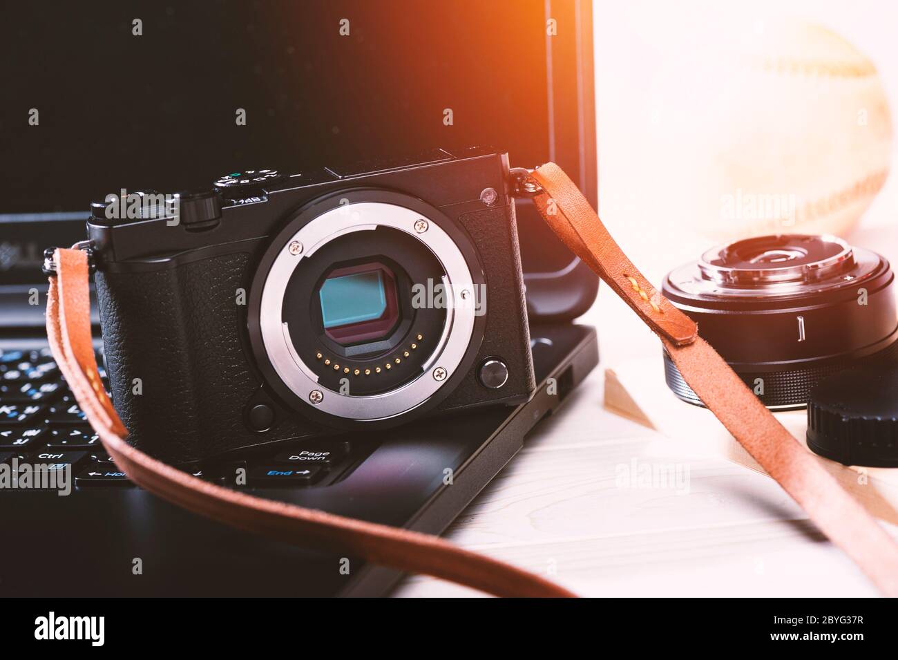 closeup vintage style of digital mirrorless camera with leather strap ...