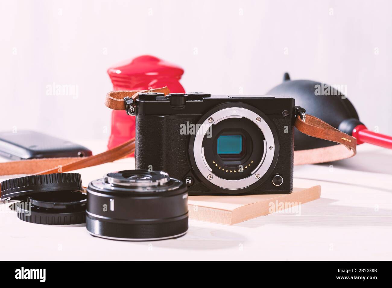 closeup vintage style of digital mirrorless camera with leather strap ...