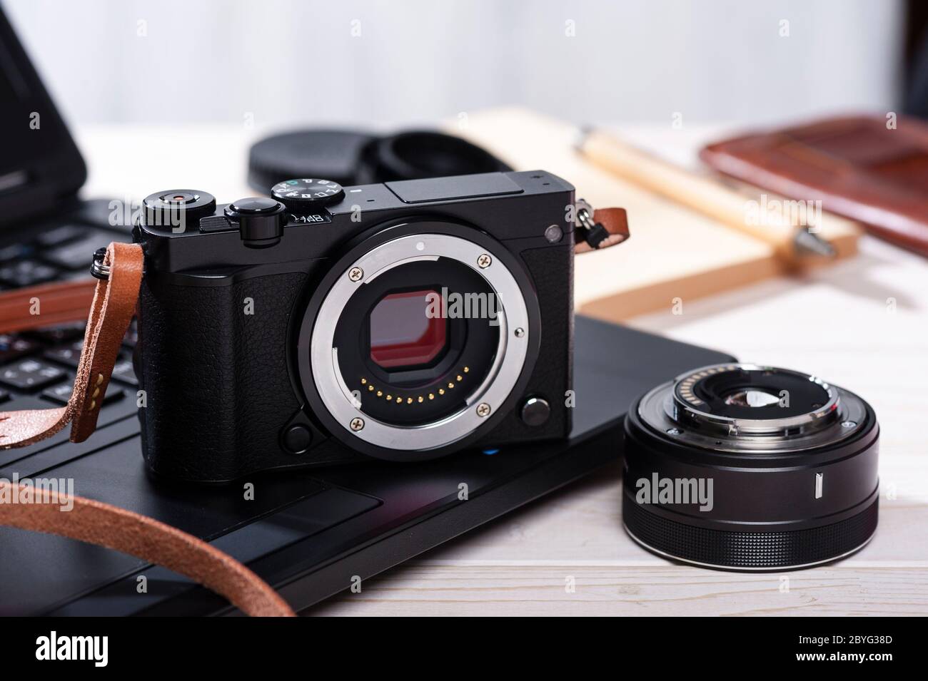 closeup vintage style of digital mirrorless camera with leather strap ...