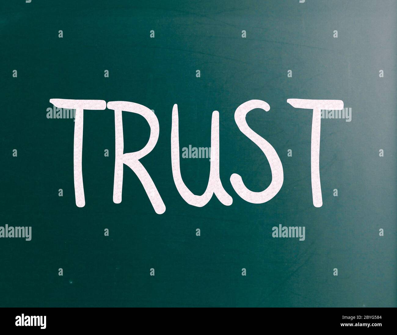 The word Trust handwritten with white chalk on a blackboard Stock Photo ...