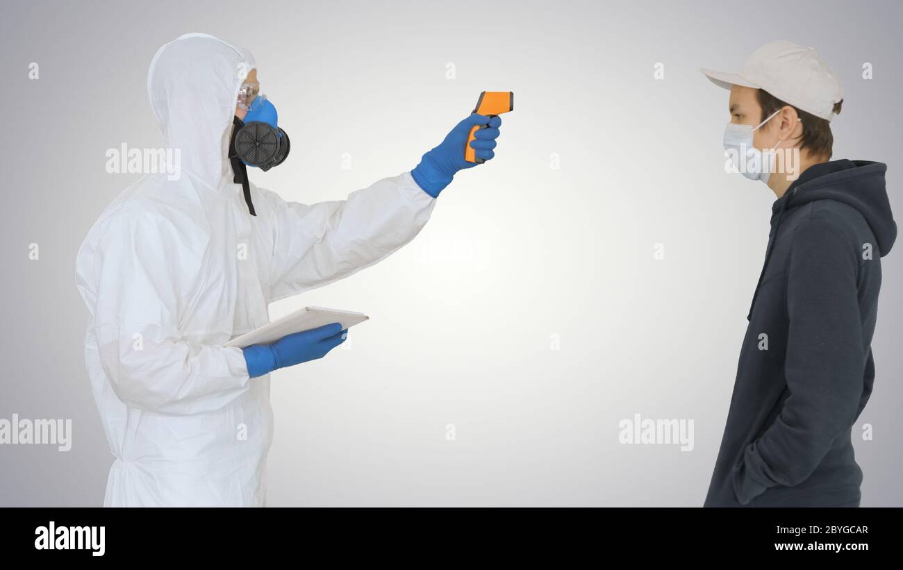 Operator check fever by digital thermometer on gradient background ...