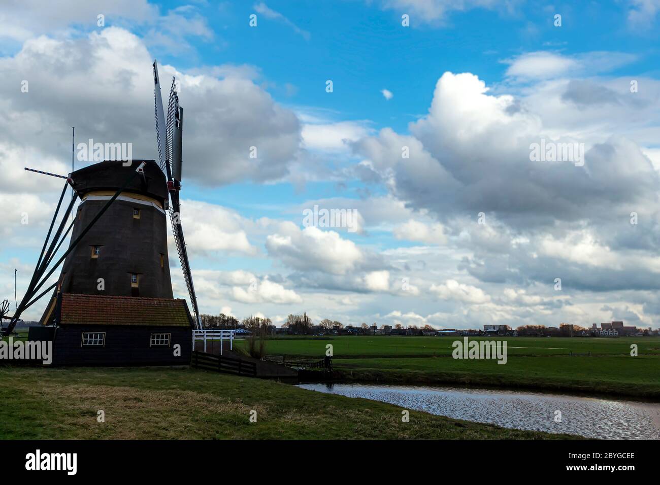 Dutch windmill facing the wind and running the turbine to pump the ...