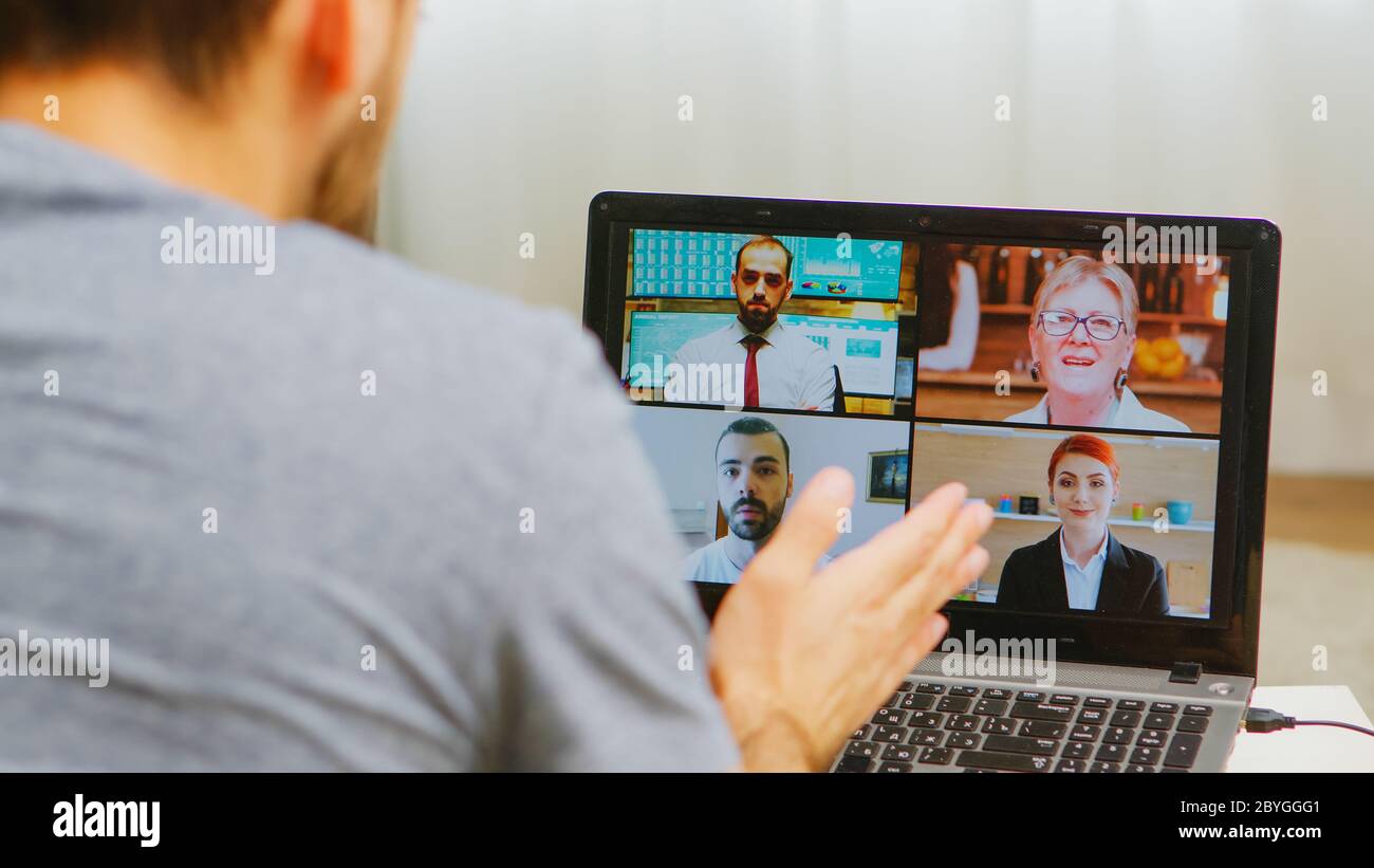 Man on a video call with work colleagues during self isolation Stock ...