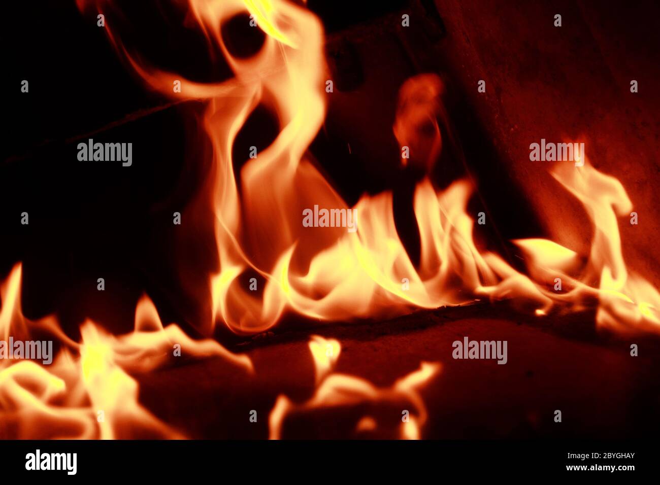 Fire flames with reflection on dark background Stock Photo - Alamy
