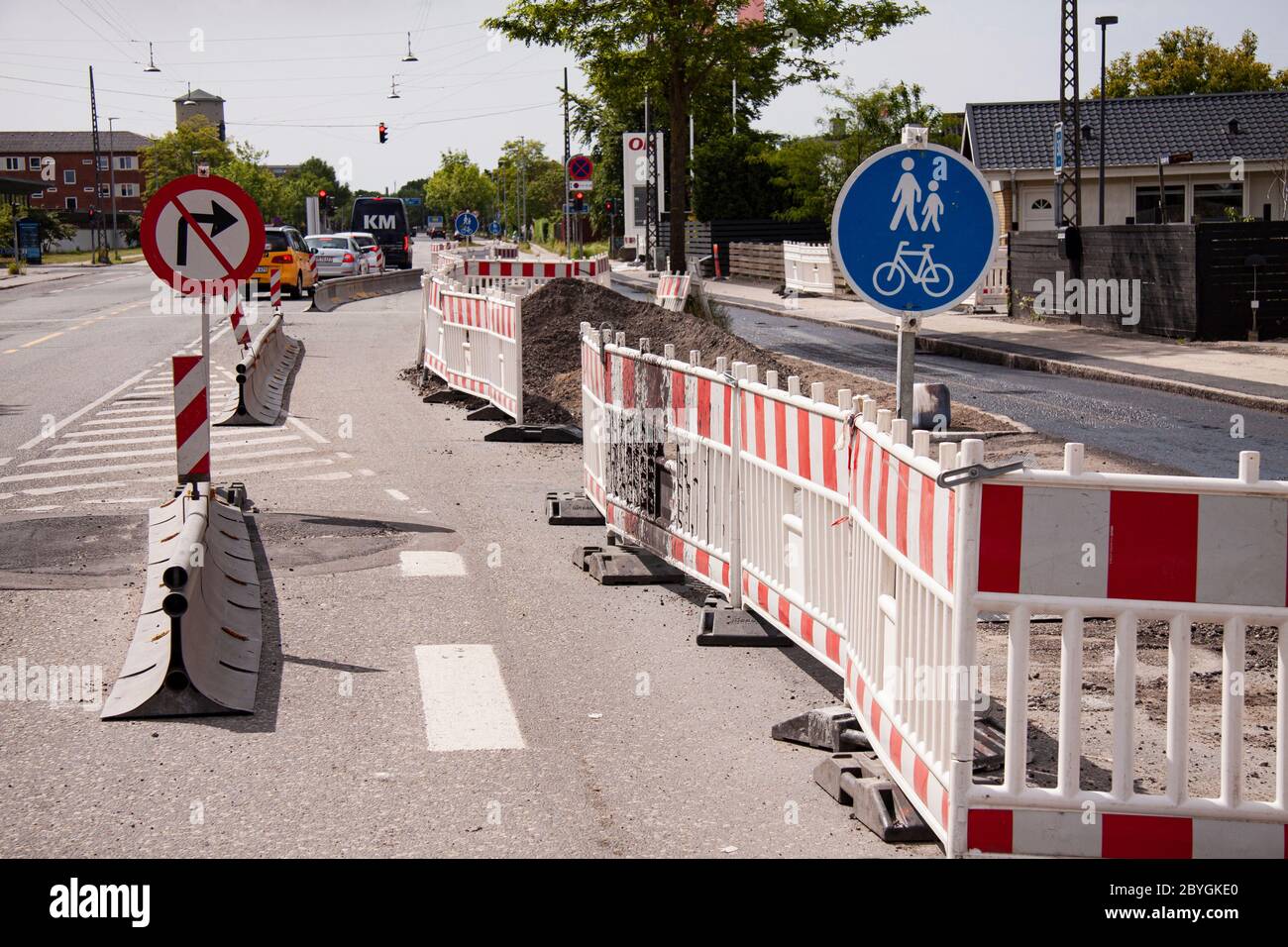 Road signs and roadworks partially blocking a road. Do not turn right ...