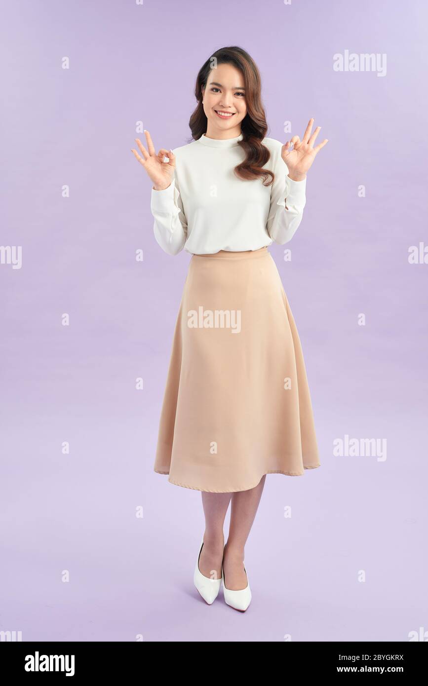 cheerful girl showing double ok-sign gesture with two hands Stock Photo ...