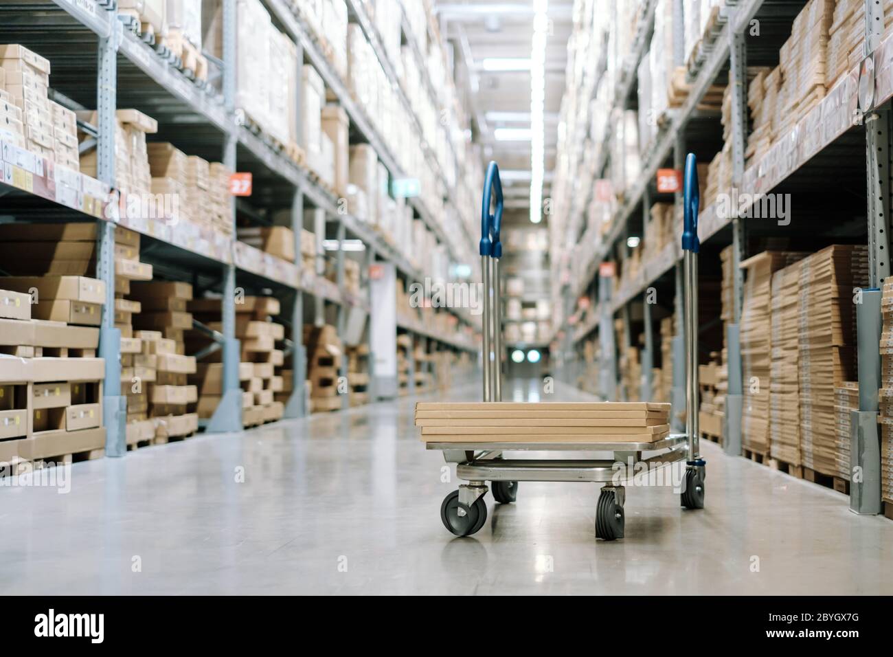Trolley with packing box in warehouse inventory storage factory ...