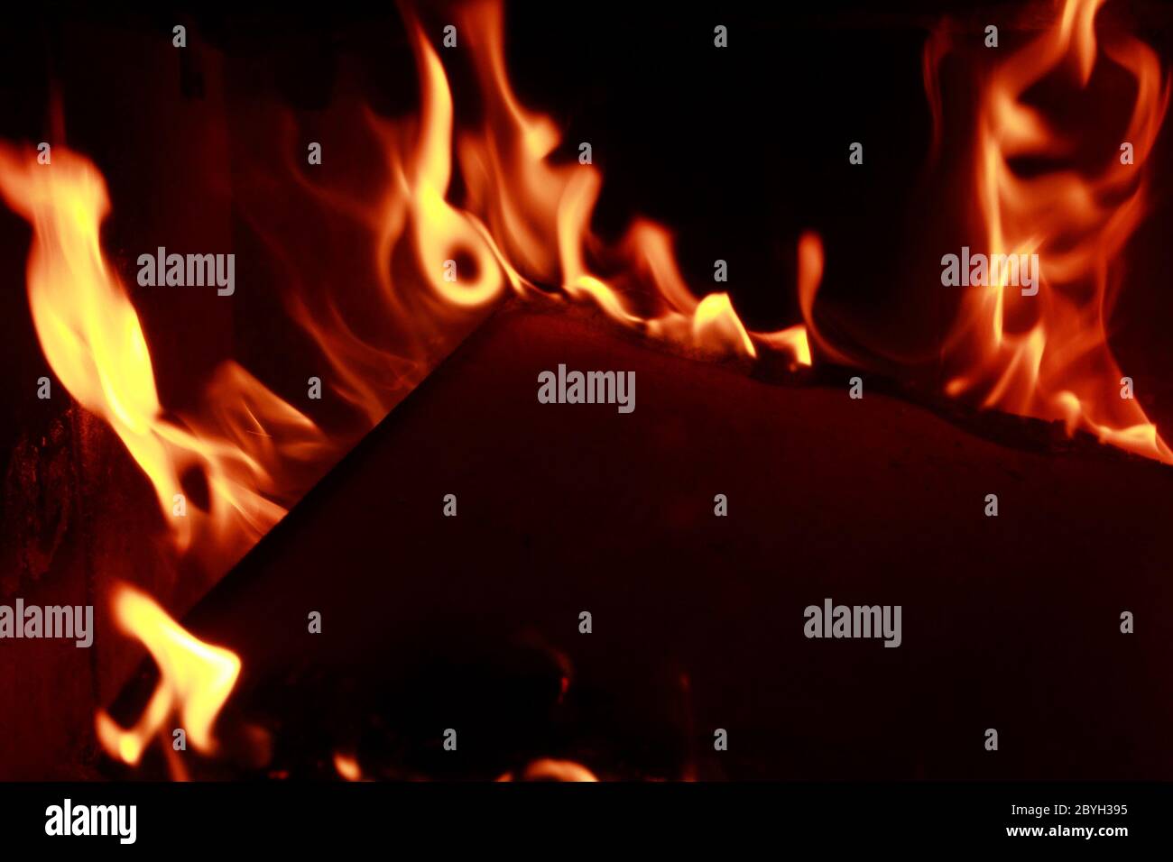 Fire flames with reflection on dark background Stock Photo - Alamy
