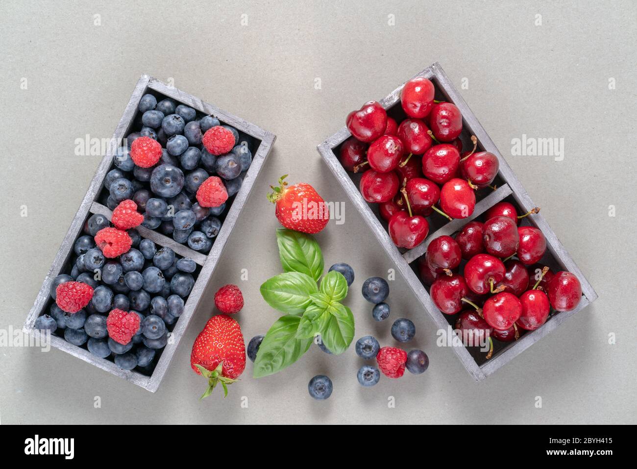 blueberries and cherries in wooden boxes Stock Photo - Alamy