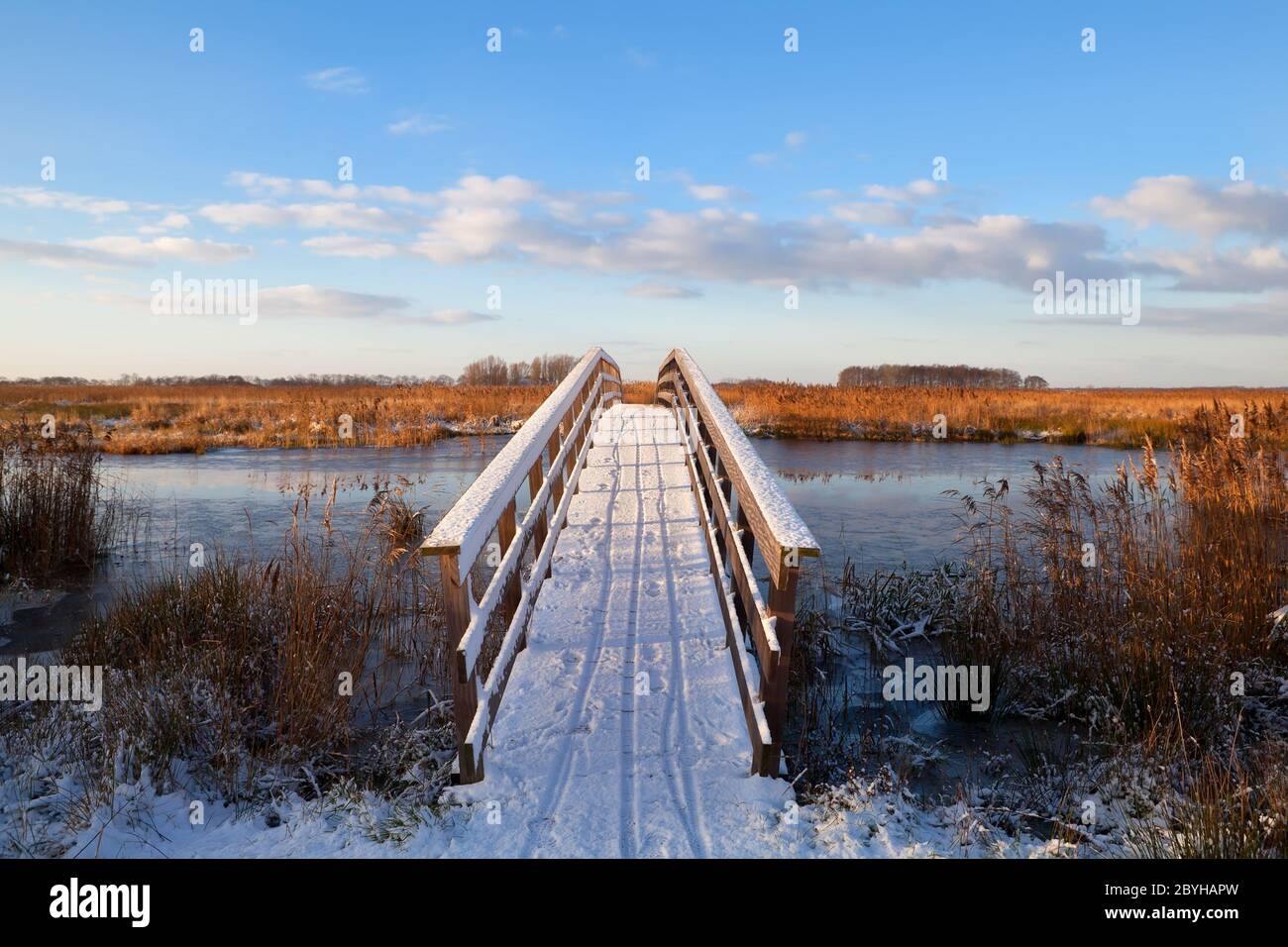 wooden bridge through river in snow Stock Photo - Alamy