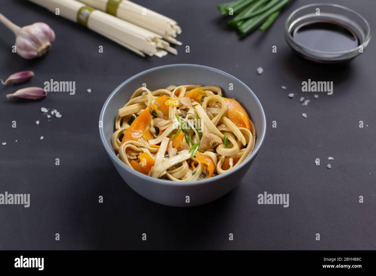 Udon noodles with chicken, soy sauce, bamboo sticks and fresh ...