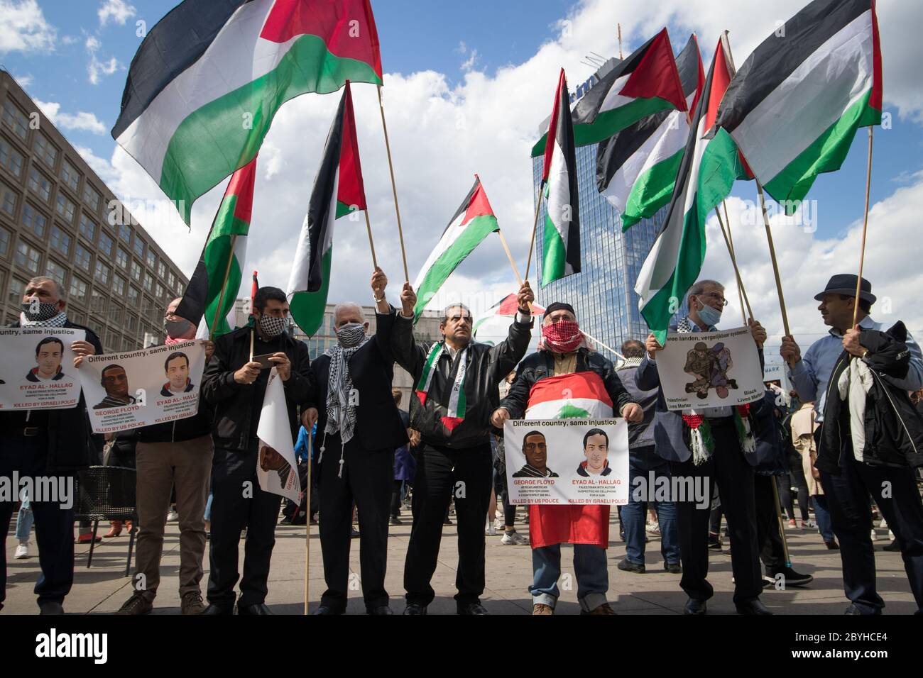 Palestinians holding Iyad Halaq signs. Thousands gathered at ...