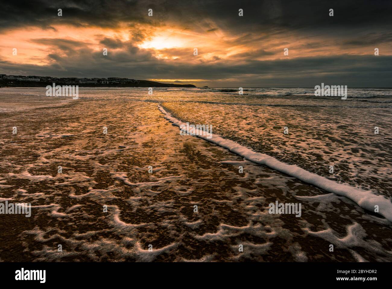 Evening light over an incoming tide at Fistral Beach in Newquay in ...