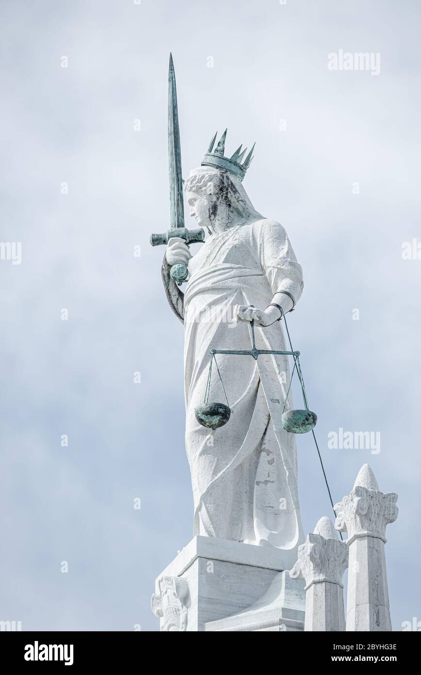 Ancient statue of goddess Justice with sword and scale at the roof top ...