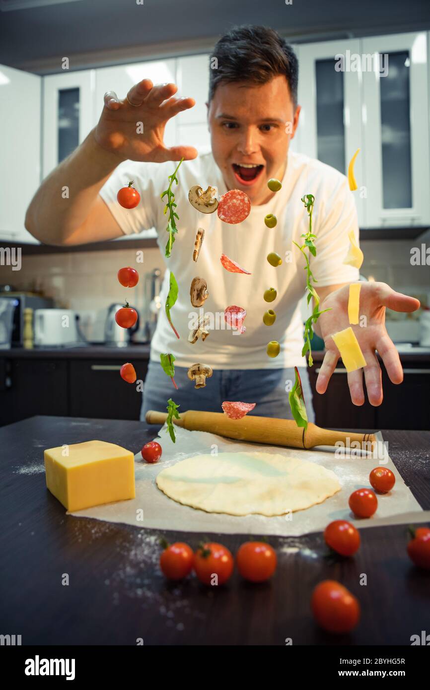 man making pizza ingredients like salami mushrooms olive cheese freeze ...