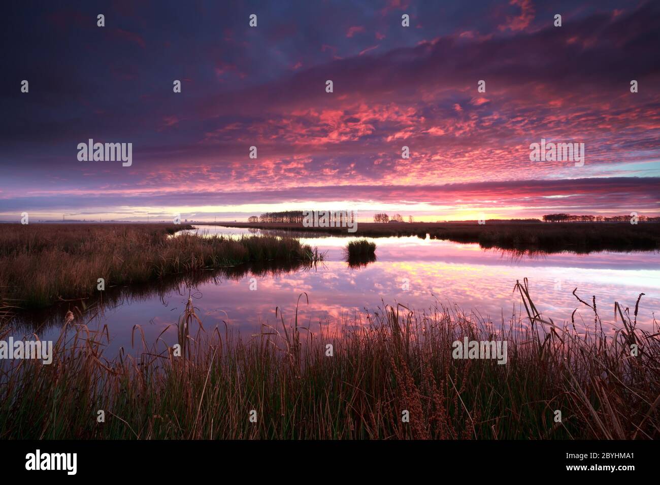 dramatic fire sunrise over river Stock Photo - Alamy