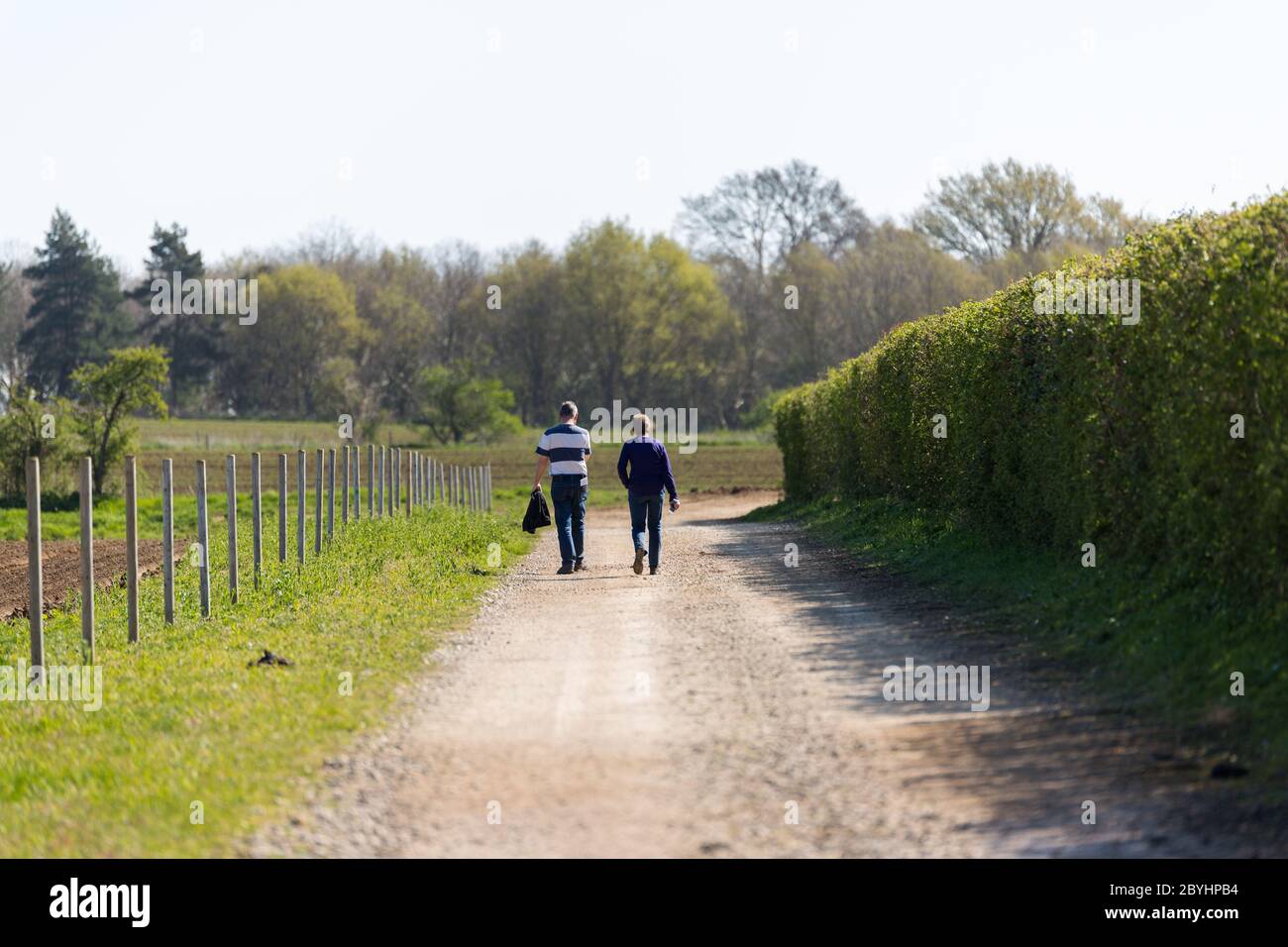 A middle aged couple taking a walk through the rural countryside on a ...
