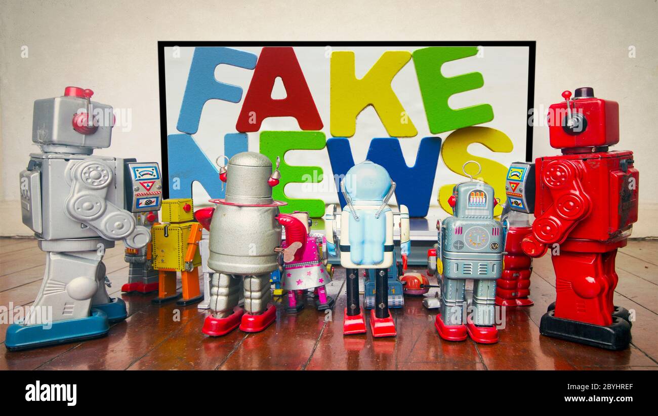 retro robots watching Fake news Stock Photo - Alamy