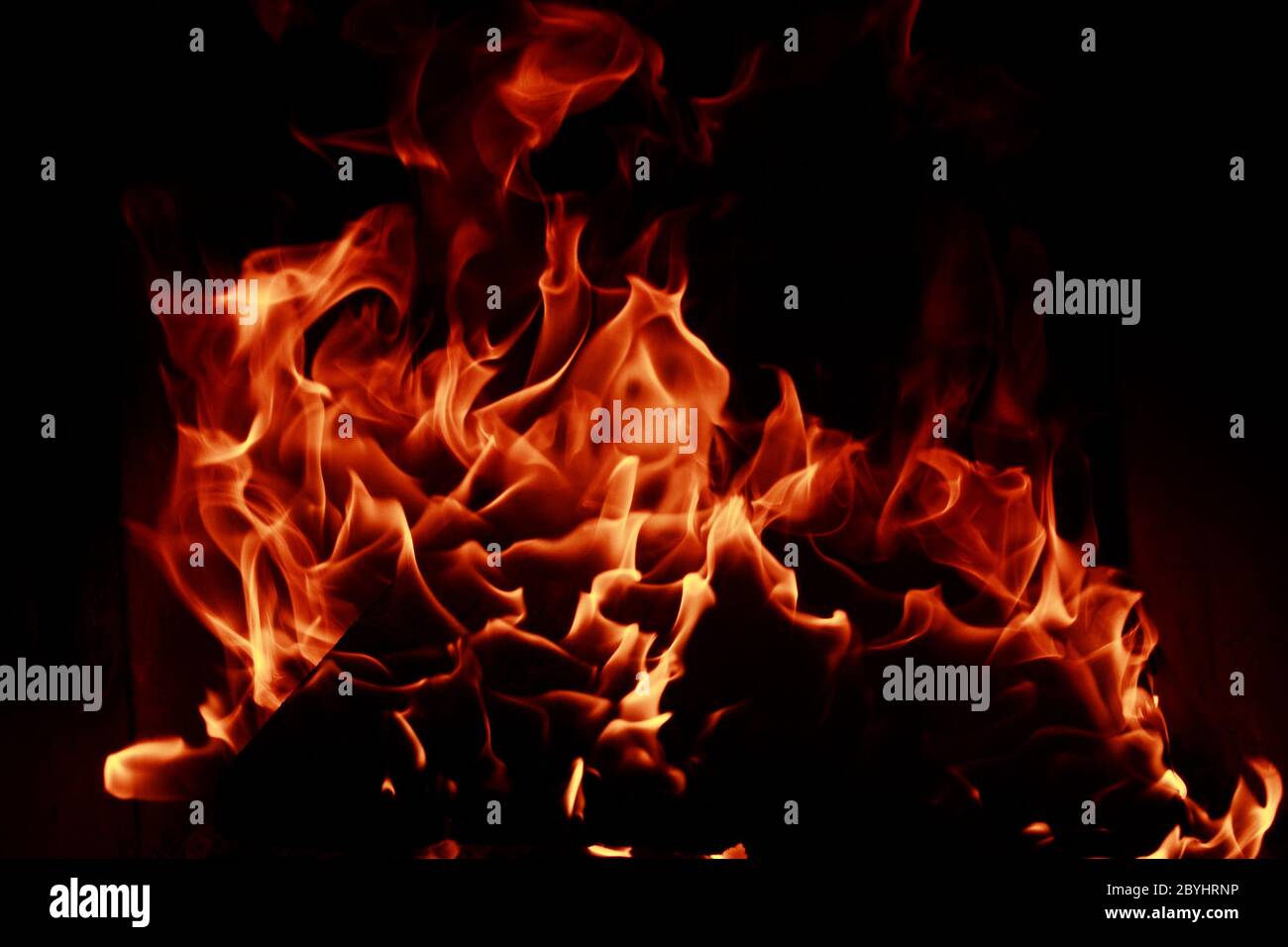 Fire flames with reflection on dark background Stock Photo - Alamy