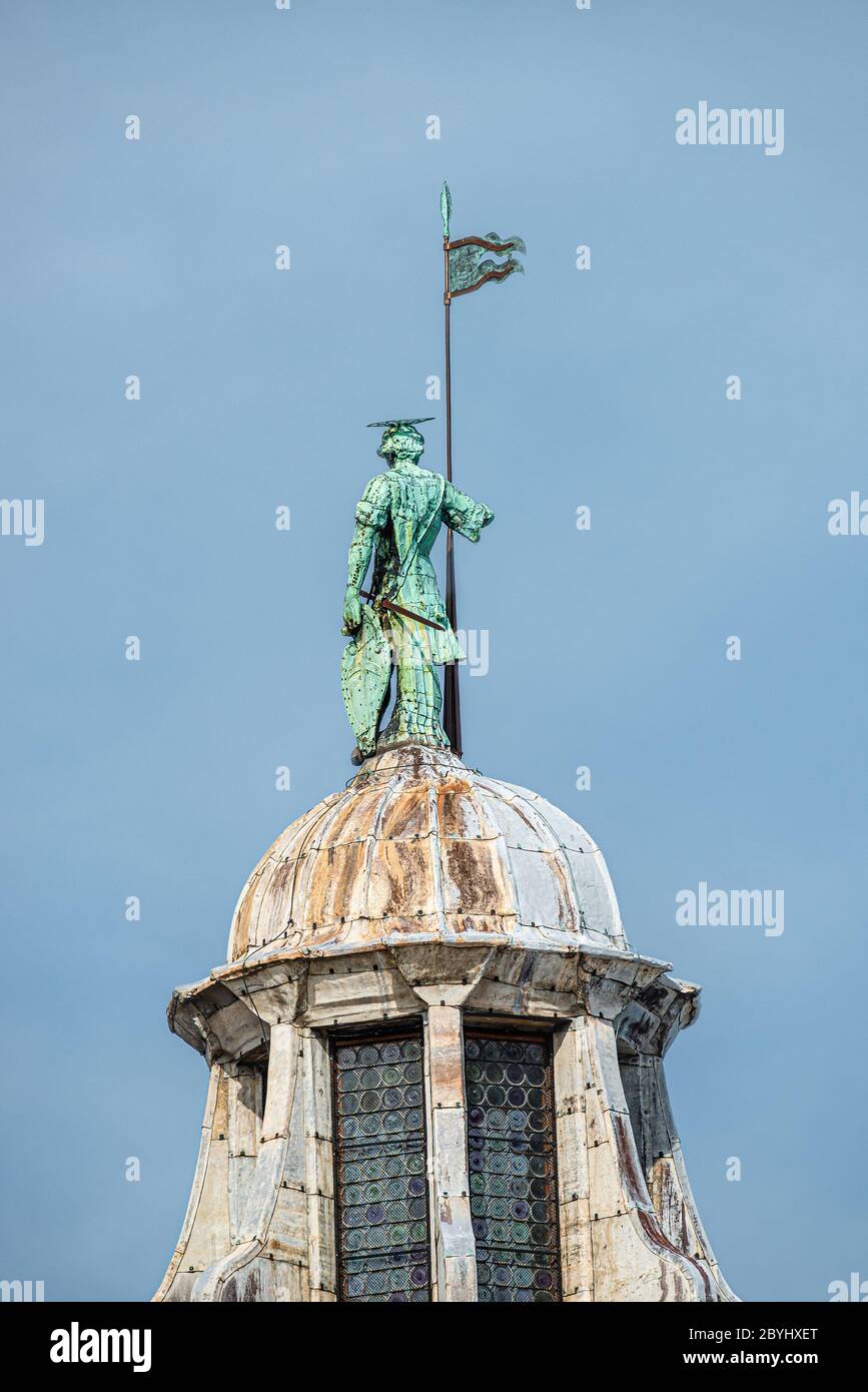 Statue of a holy knight with shield, sword and spire at the dome of San ...